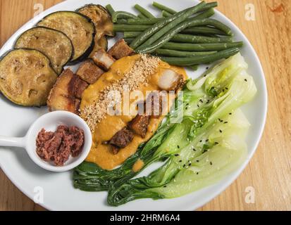 Crispy Kare Kare Pork Belly Are Sauce With Peanuts And Vegetables