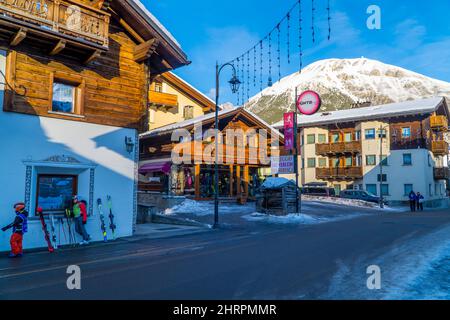 Traditional alpine houses with shops and people Stock Photo - Alamy