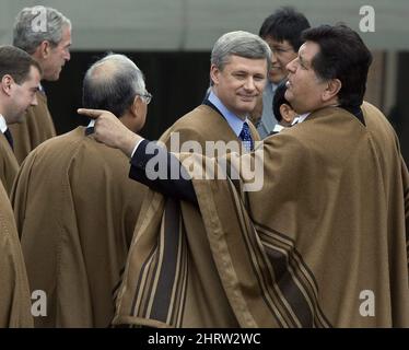Prime Minister Stephen Harper, wearing body armour, gives a thumbs-up ...