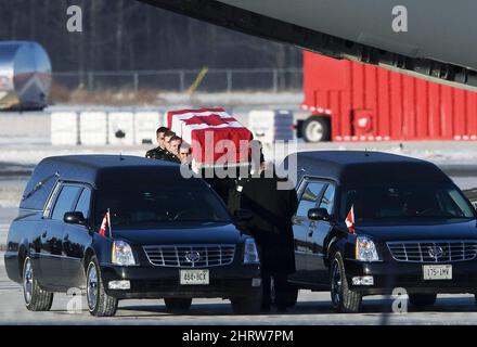 Military pallbearers carry the caskets of three fallen Canadian ...