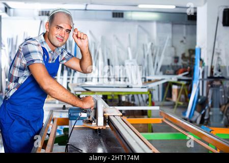 Machine cutting pvc profile. Production of PVC windows, a section of ...