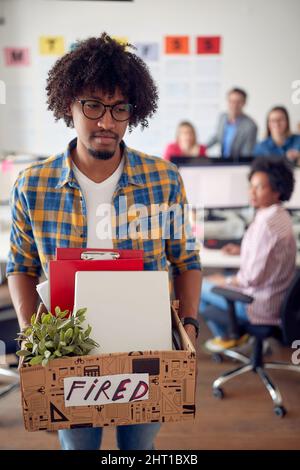 Young man getting fired from his job Stock Photo - Alamy