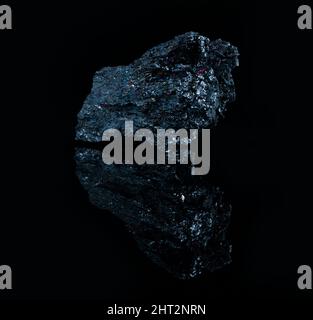 Vertical shot of a bornite mineral isolated on black background Stock ...