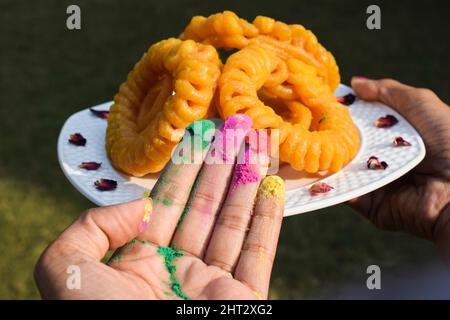 Female holding Imarti sweets, popular sweet dish from India. Circular ...