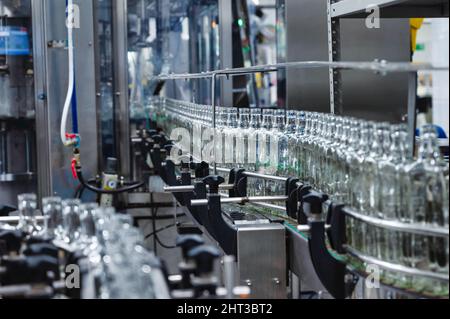 Production line transports empty glass bottles for alcohol Stock Photo ...