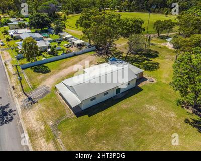 Aerial View of the town of Gilgai surrounded by green rainforests in ...