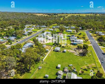 Aerial View of the town of Gilgai surrounded by green rainforests in ...