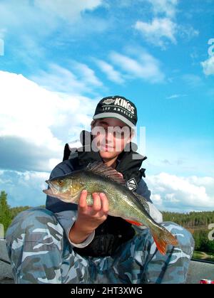 Boy with perch catch Stock Photo - Alamy