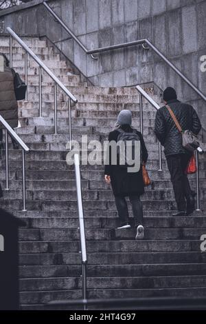 Vertical shot of people going upstairs Stock Photo - Alamy