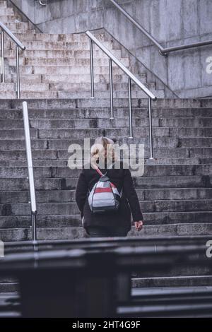 Vertical shot of people going upstairs Stock Photo - Alamy