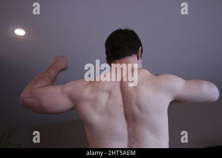 man flexing back in selfie type photo Stock Photo - Alamy