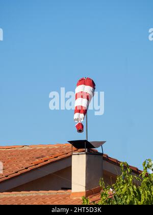 red white windsock on building roof Stock Photo - Alamy