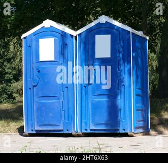 Two portable toilet cabins in park at dry sunny summer day Stock Photo ...