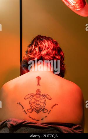 Spanish woman with a turtle tattoo on her back inside a physical ...