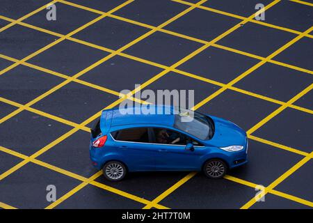 Cars drive through a yellow box junction in Cardiff, Wales, United ...