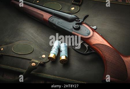 Classic trigger double-barreled hunting rifle on a wooden background ...