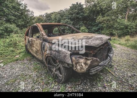 HDR bruned car lost place abandon Stock Photo - Alamy