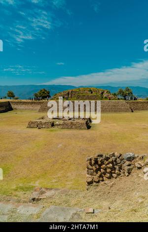 Zapotec temples with tourists inside the Monte Alban archaeological ...