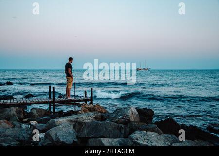 Ukrainian man on a pier during sunset Stock Photo - Alamy