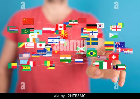 3d floating icons of countries' flags and binary code over a hand - a ...
