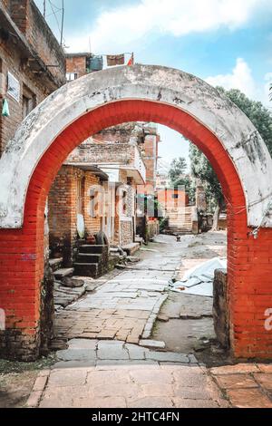 Golden gate of a Nepalese temple with traditional sculptures under a ...