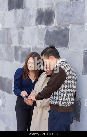 Office mates talking together while looking at the phone Stock Photo ...
