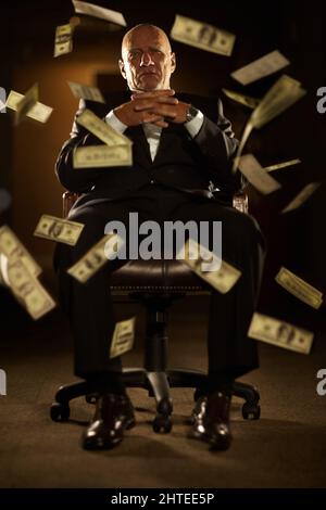 Crime is all about control. Aged mob boss smoking a cigar and looking ...