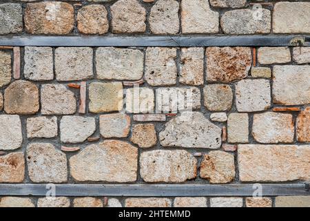 The antique wall is paved with gray stones, top view. stone texture ...