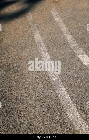 Asphalt Road with Faded White Line Marking Stock Photo - Alamy
