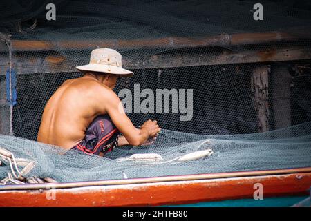 Khmer fisherman fixing his fishing nets Stock Photo - Alamy