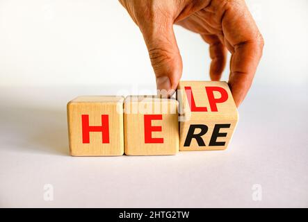 Help is here support symbol. Businessman turns the wooden cube and ...