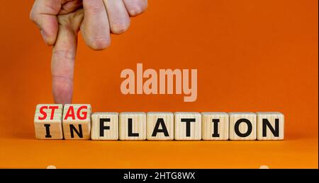 Inflation and stagnation symbol. Businessman turns cubes, changes the ...