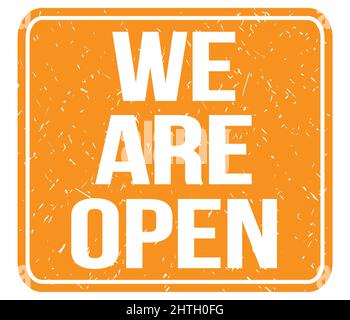 WE'RE OPEN text written on orange rectangle stamp sign Stock Photo - Alamy