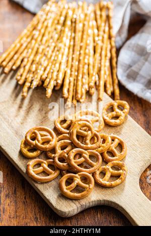 Mini pretzels and salted sticks. Crusty salted snack on kitchen table ...