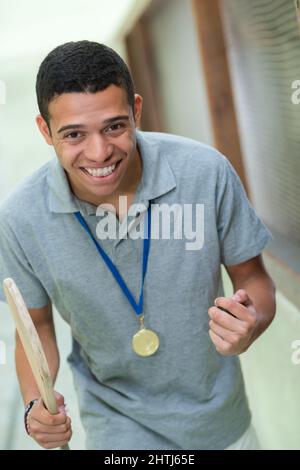 Happy tennis winner with winner’s cup and medal on court Stock Photo ...