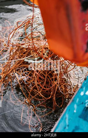 High angle of bunch of entangled fishing nets launched from boat in ...