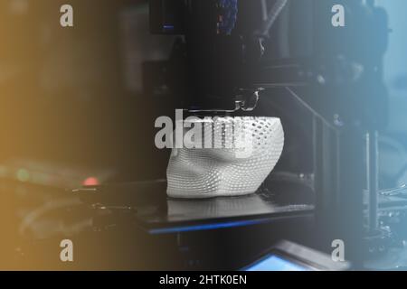 The 3D printer prints white plastic model Stock Photo - Alamy