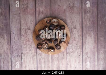 raw champignon mushroom on a chopping board on table Stock Photo - Alamy