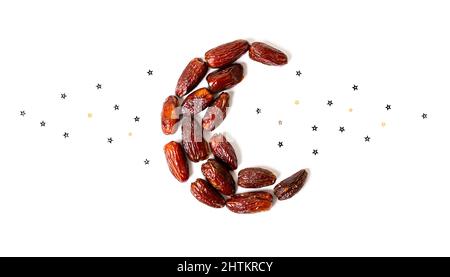 Ramadan kareem with dried fruits arranged in shape of crescent moon ...