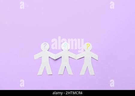 Paper human figures with question marks on lilac background. Concept of ...