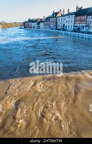 Powerful torrents of surging river water,from surrounding hills and ...