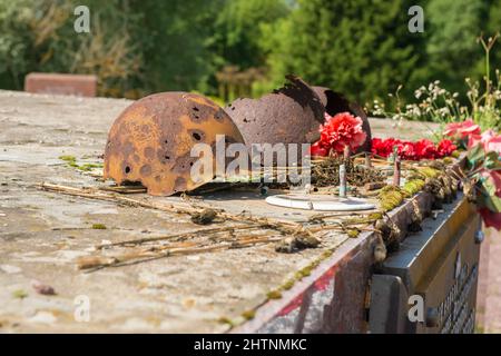Old rusty and punctured soldiers' helmets decorated with flowers Stock ...
