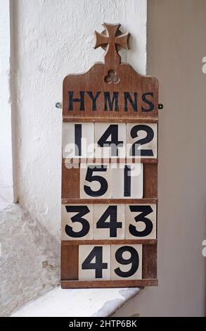Hymn board numbers on a church bench Stock Photo - Alamy
