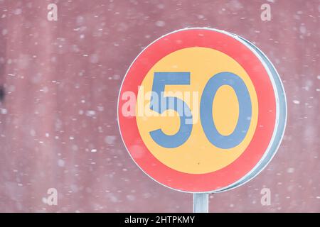 50 kmh speed limit sign on a pole. The traffic sign forbids car drivers ...