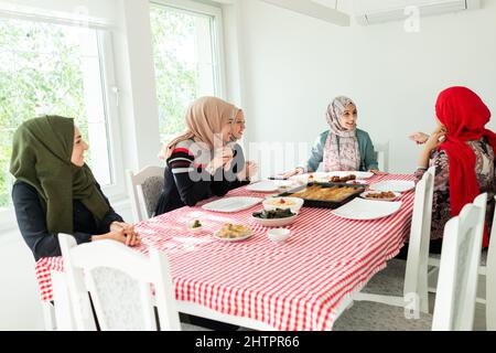 Arabic muslim family eating together in a meeting for iftar in ramdan ...