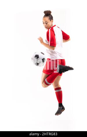 Football player kicking a ball with back heel isolated on white ...