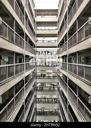 Interior of multi-storey residential building with stairs between ...