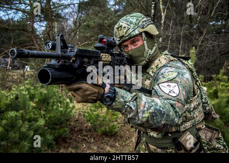 Dutch soldier in a new uniform in NFP camouflage lying on the ground ...