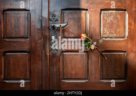 Single Rose At The Closed Gate Of A Church Stock Photo - Alamy