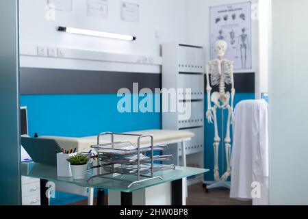 Interior of empty doctors office with body description banner on wall ...